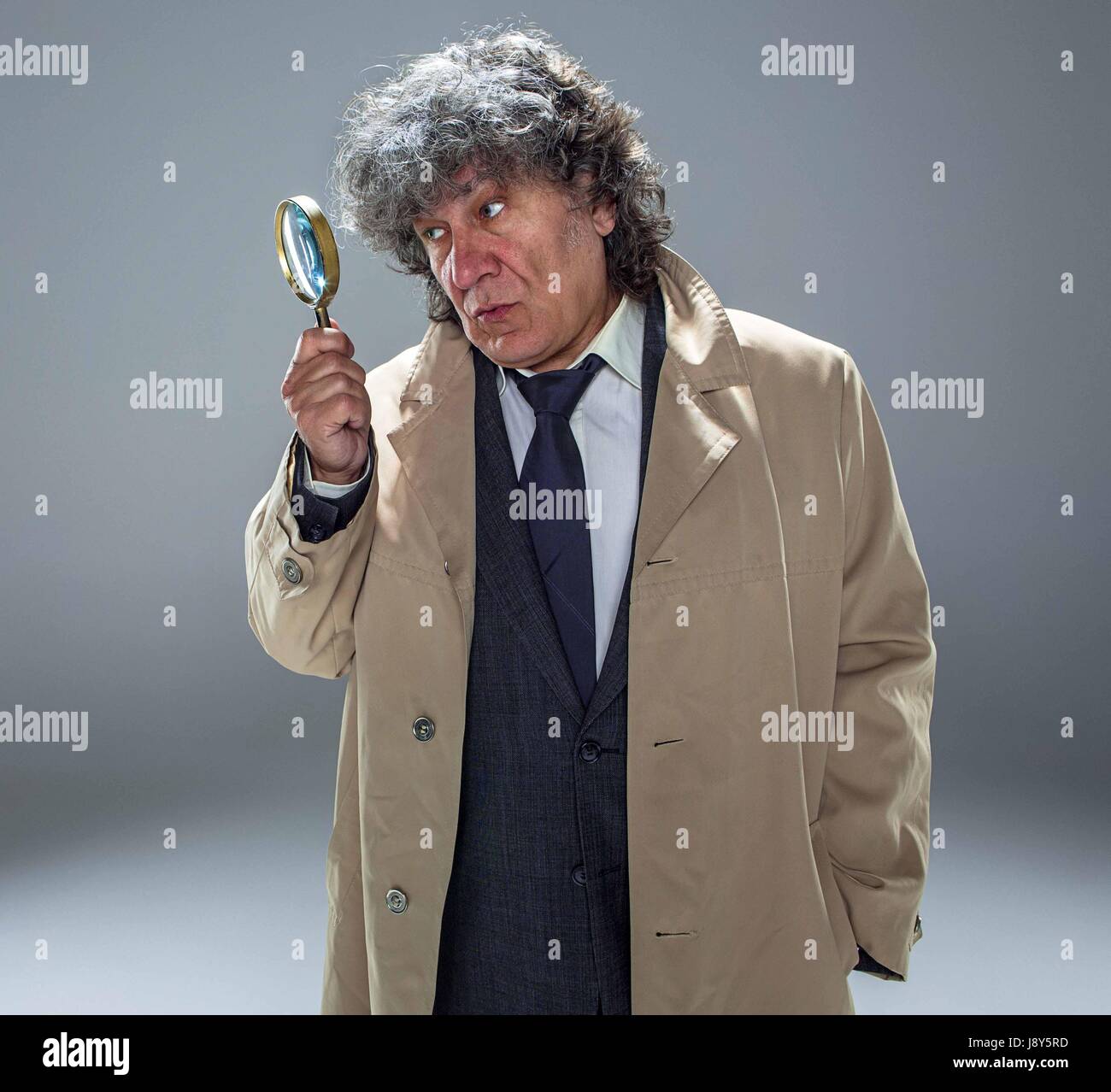 The senior man as detective or boss of mafia on gray studio background ...