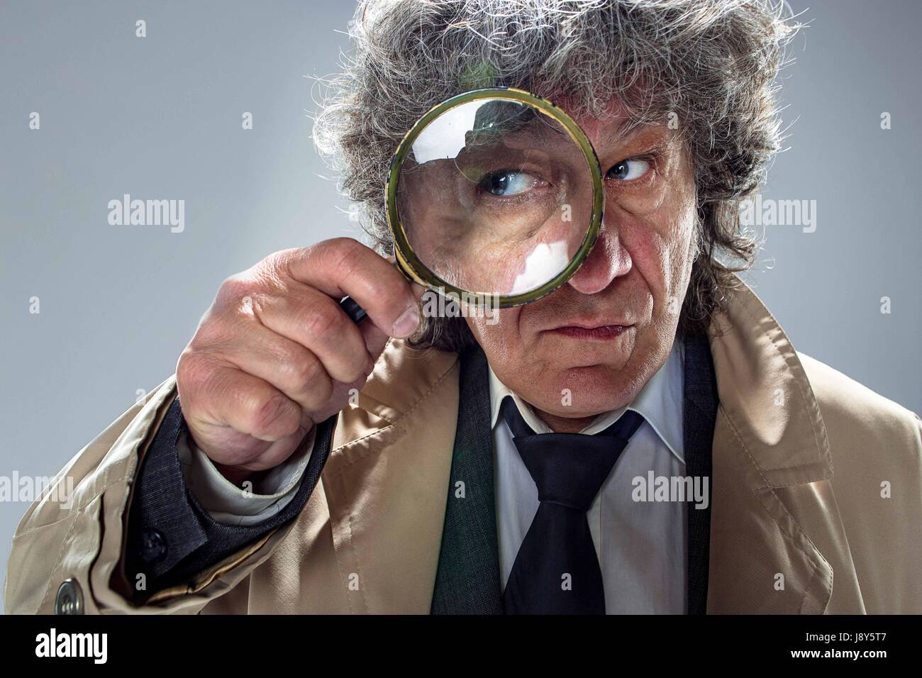 The senior man as detective or boss of mafia on gray studio background ...