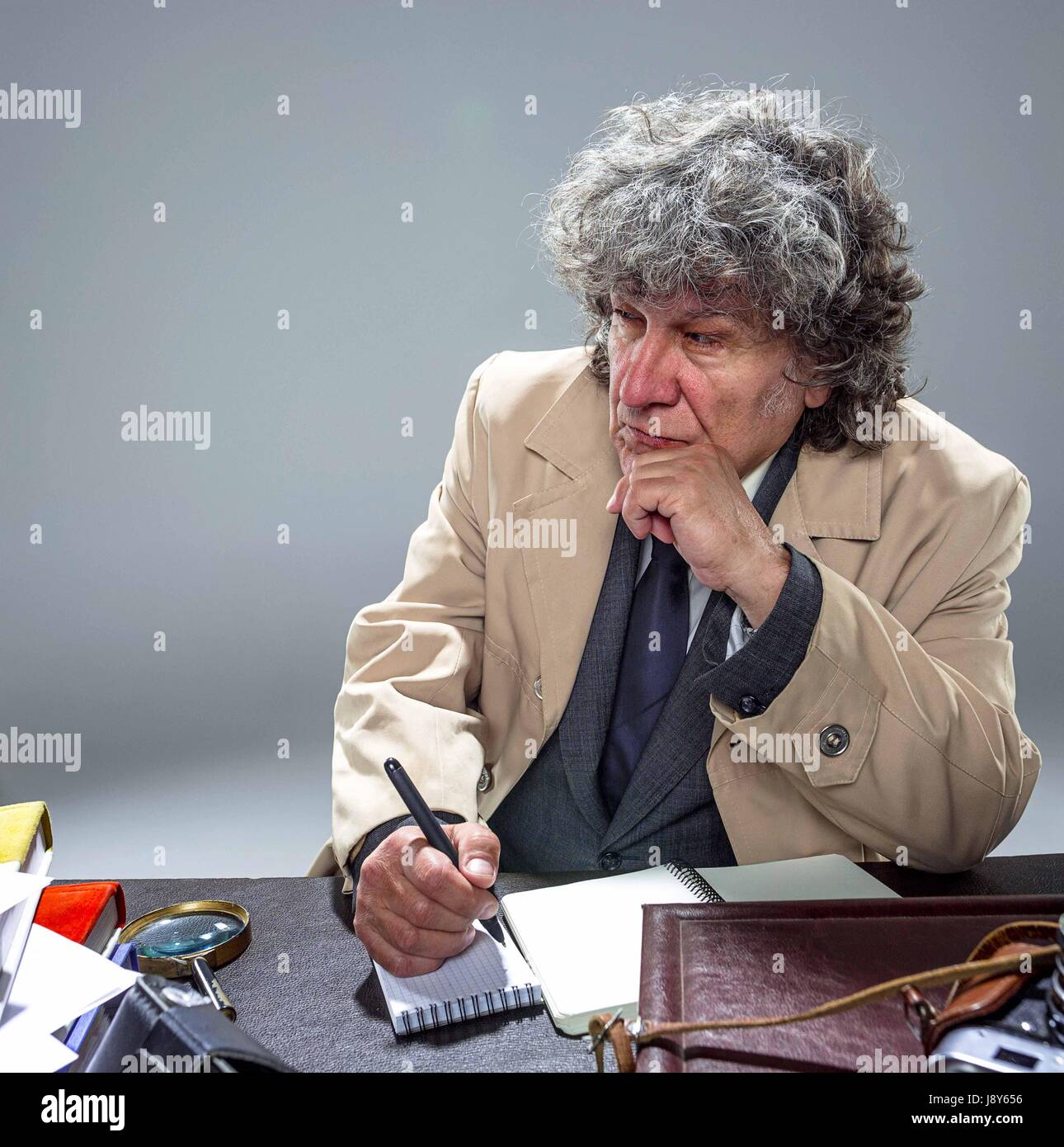 The senior man as detective or boss of mafia on gray studio background ...