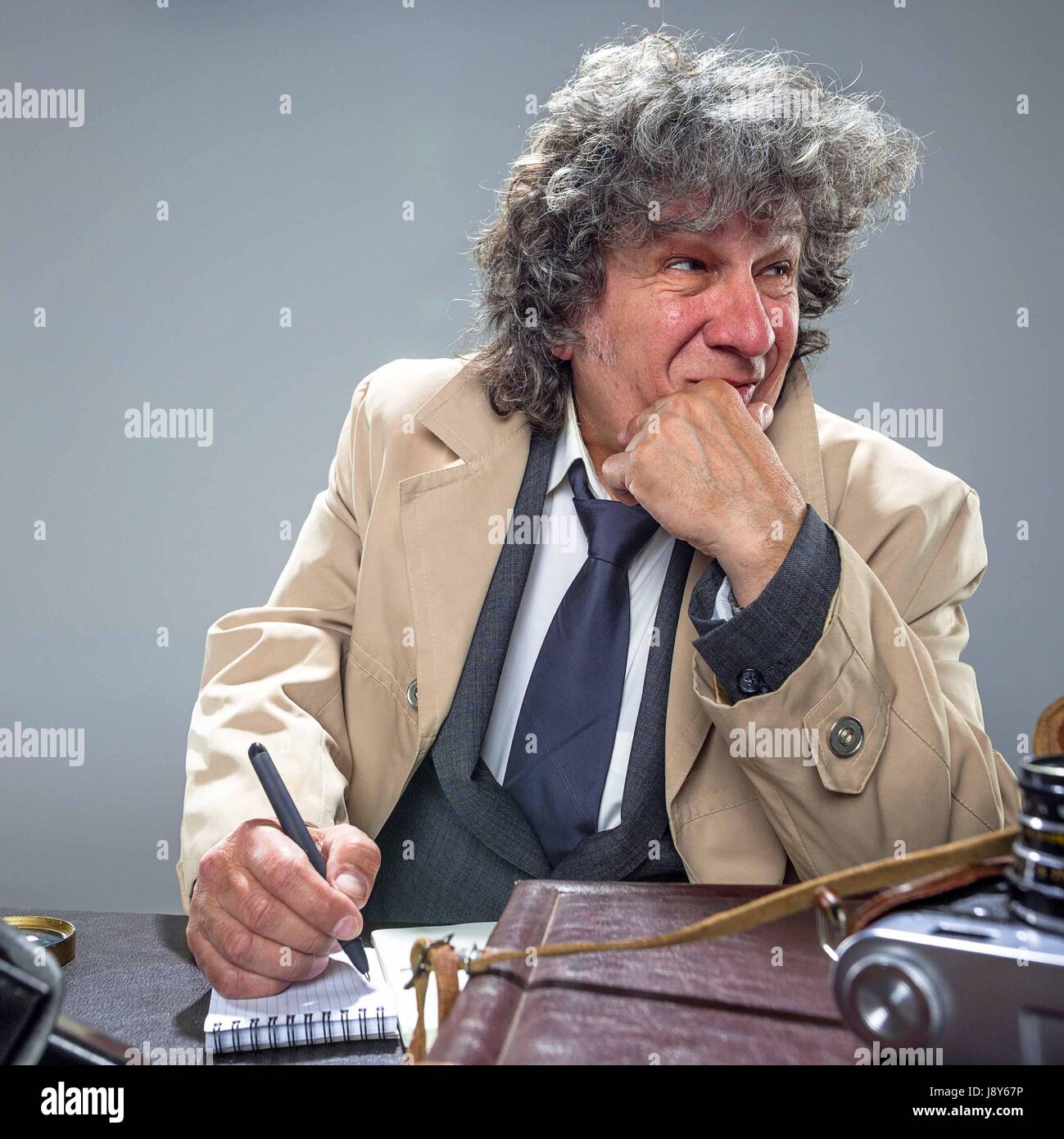 The senior man as detective or boss of mafia on gray studio background ...