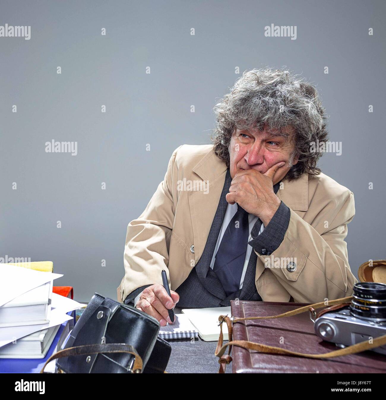 The senior man as detective or boss of mafia on gray studio background ...