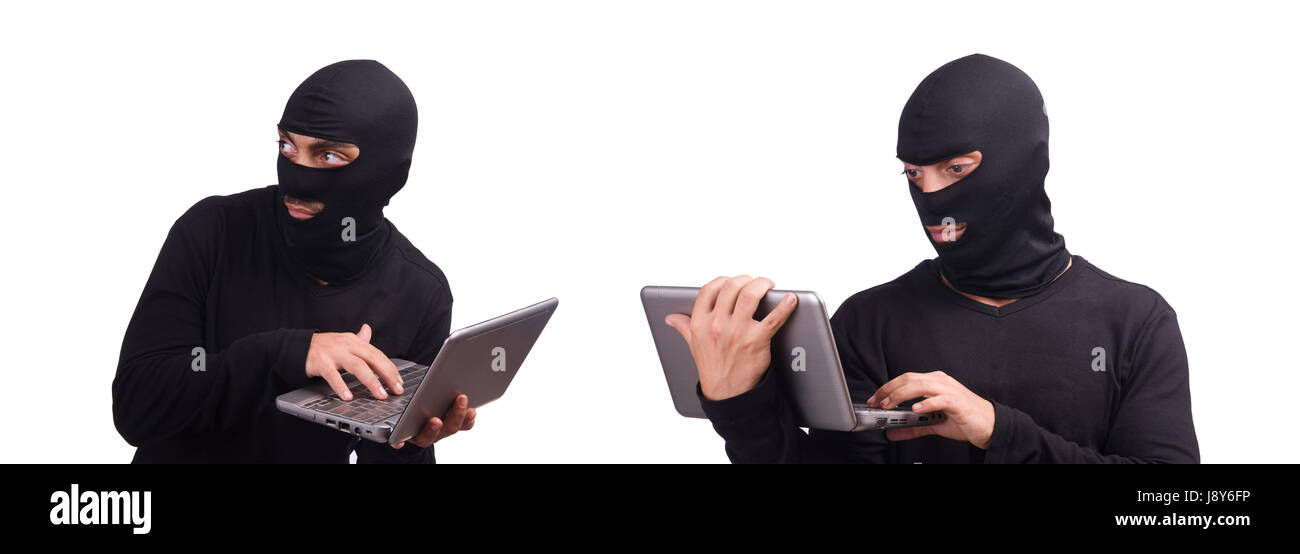 Hacker with computer wearing balaclava Stock Photo - Alamy