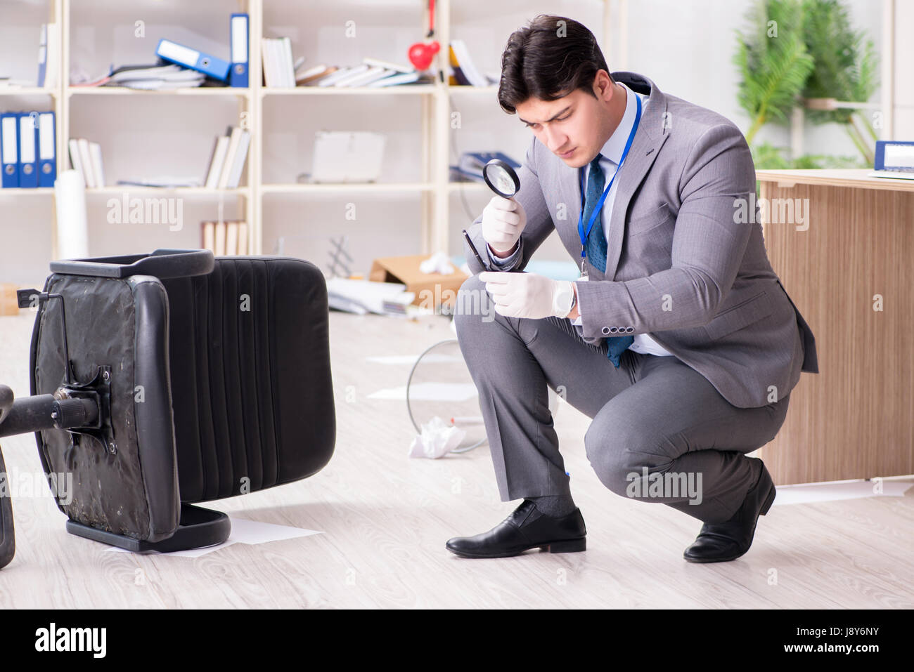 Young man during crime investigation in office Stock Photo - Alamy