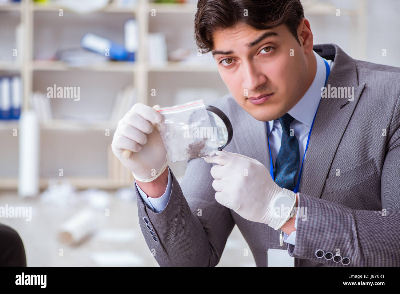 Young man during crime investigation in office Stock Photo - Alamy