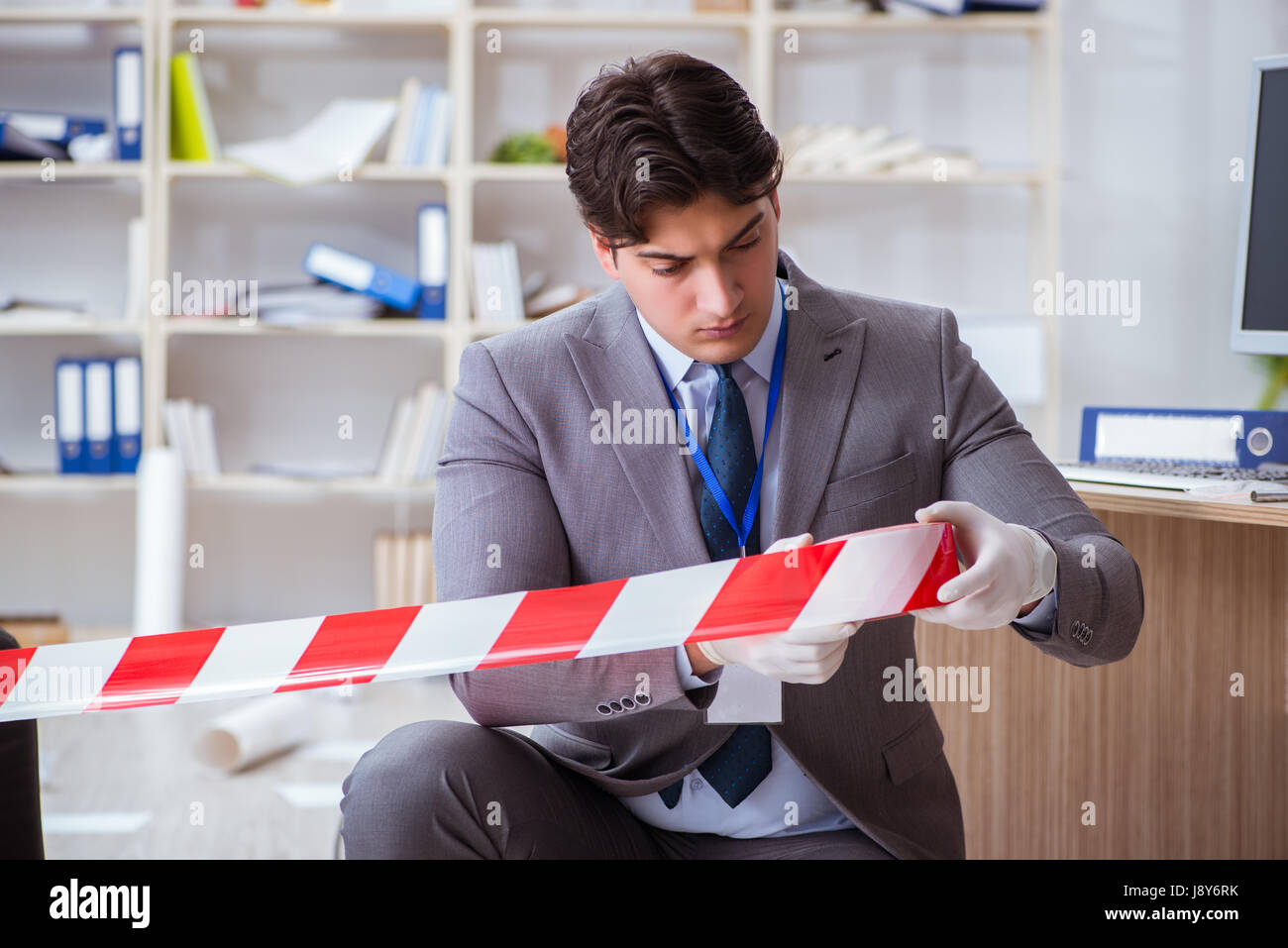 Young man during crime investigation in office Stock Photo - Alamy