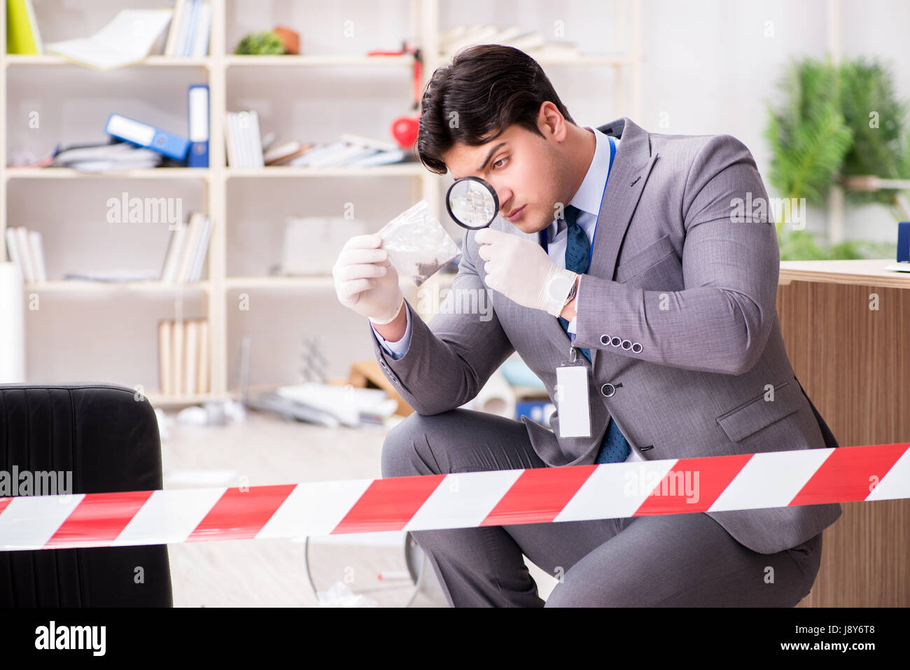 Young man during crime investigation in office Stock Photo - Alamy