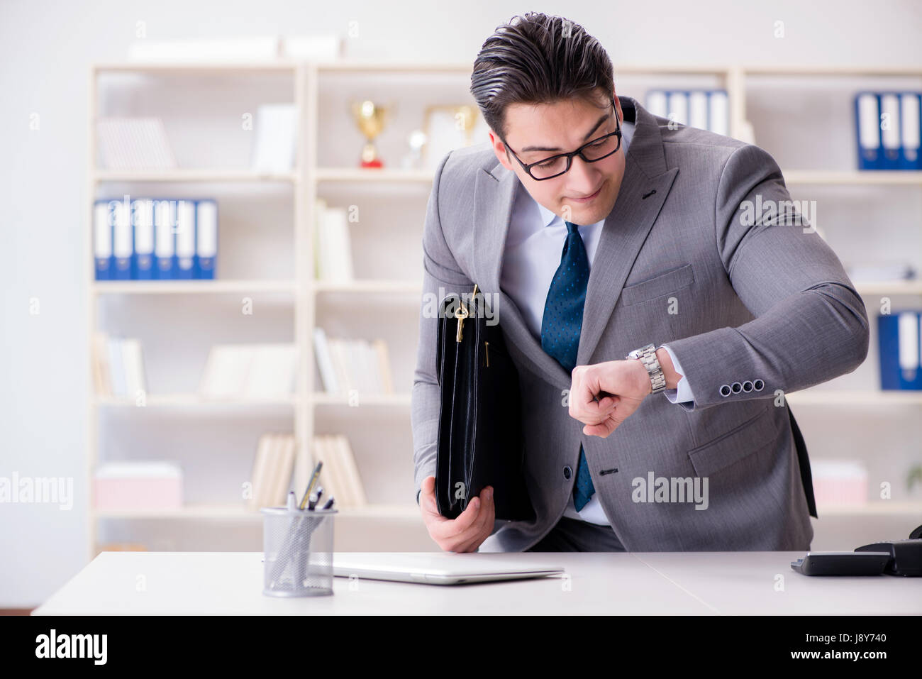 Businessman rushing in the office Stock Photo - Alamy