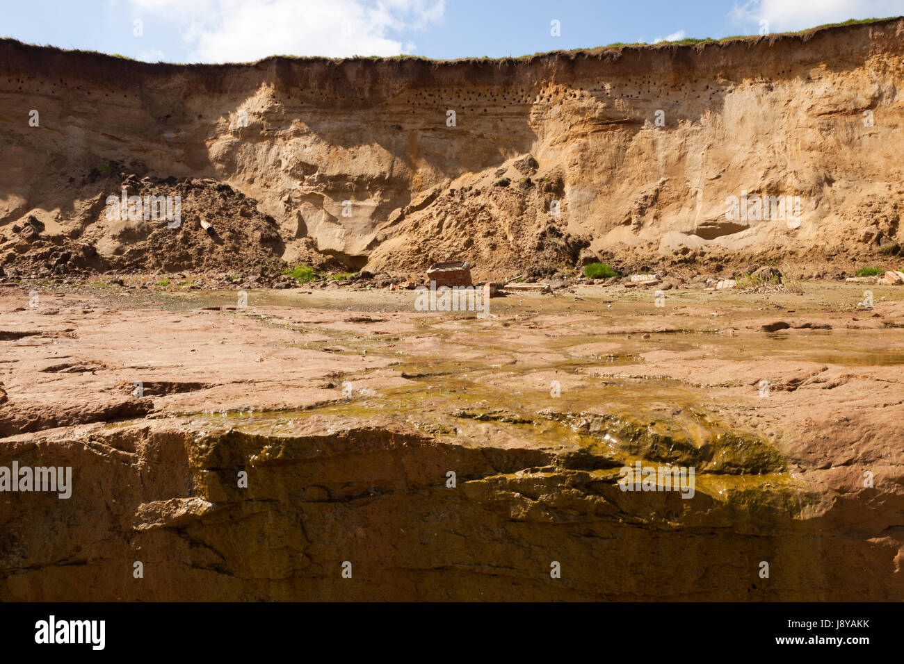 Crumbling cliffs at Happisburgh in Norfolk England, UK showing debris ...