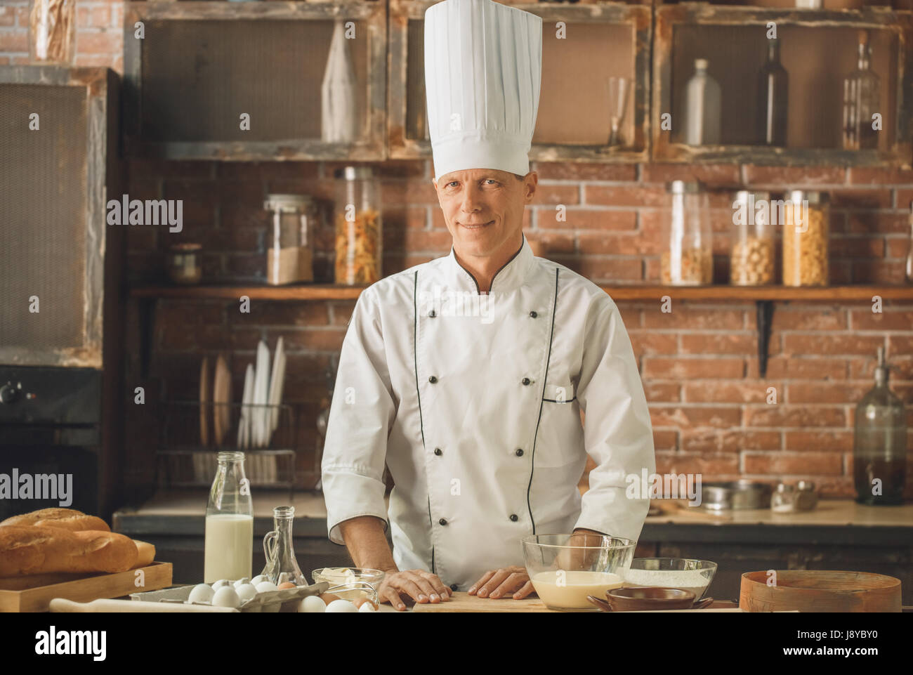 Bakery chef cooking bake in the kitchen professional Stock Photo - Alamy