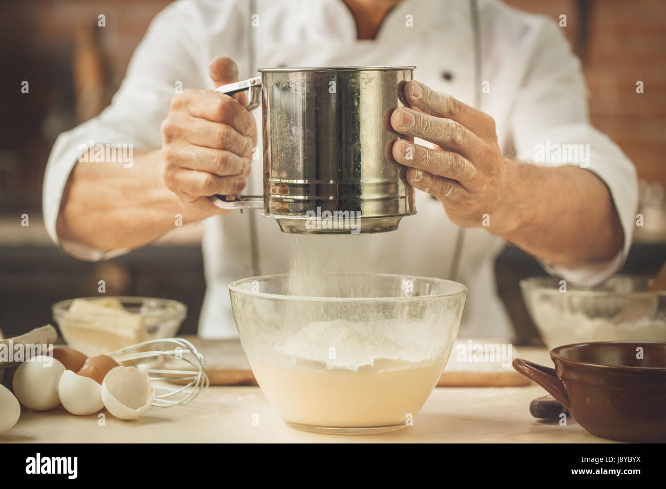 Bakery chef cooking bake in the kitchen professional Stock Photo - Alamy