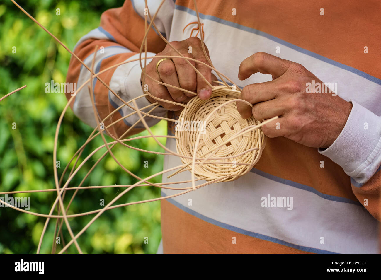 Basket-maker creates a new basket - Folk art Stock Photo - Alamy