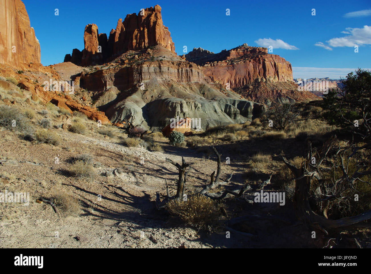 hiking trail between multicolored rock formations,capitol reef national ...