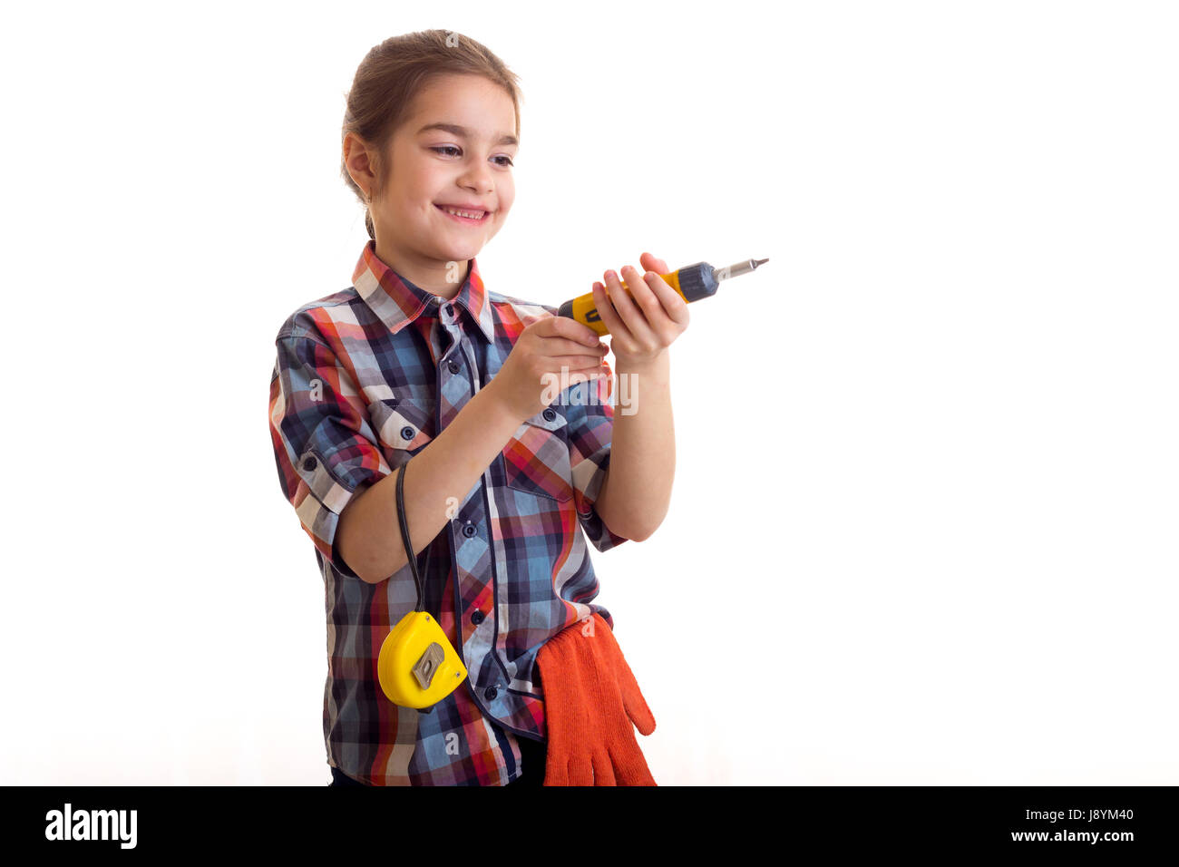 Little girl holding screwdriver and roulette Stock Photo - Alamy