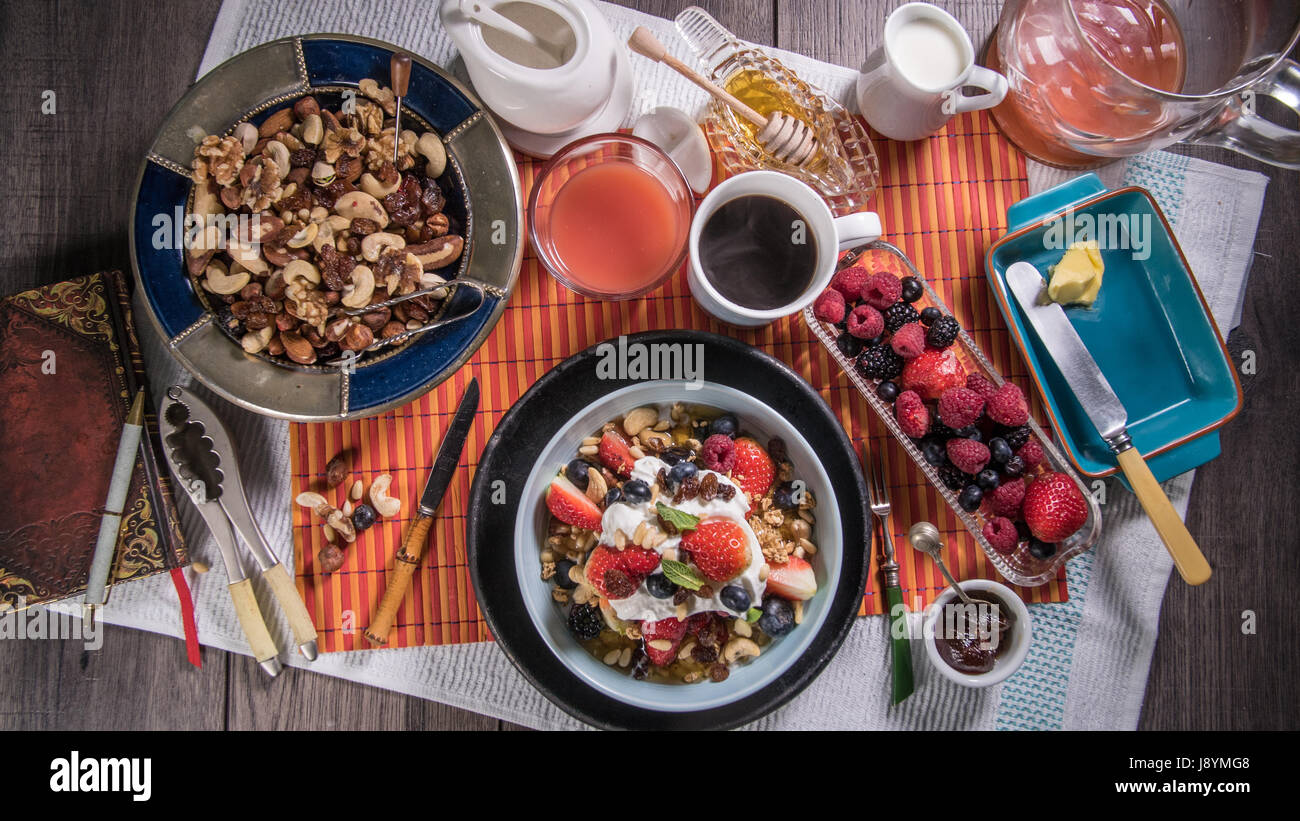 Top down view of a healthy breakfast of yogurt, cereals, berries and ...
