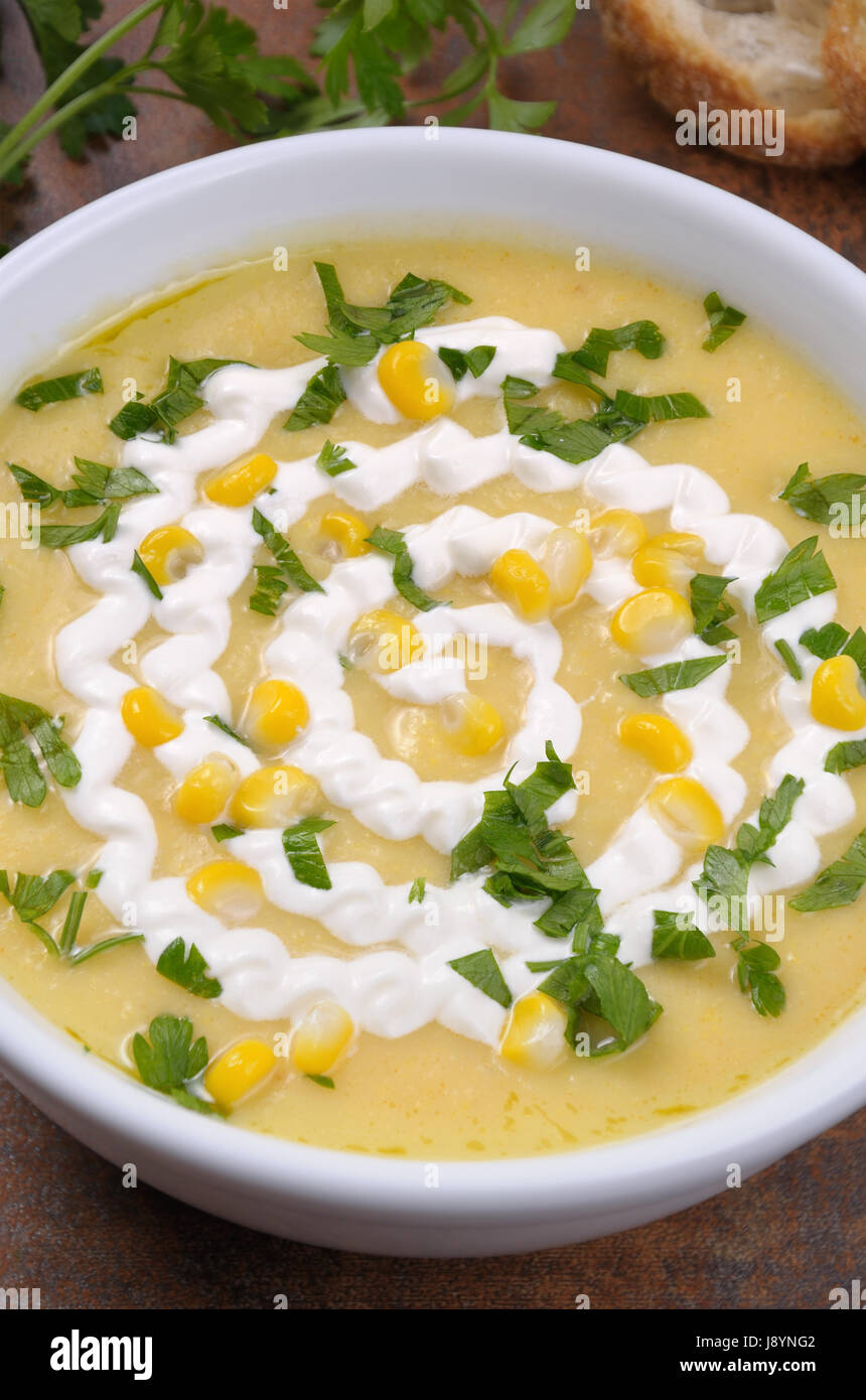 Puree soup mealies seasoned with grains of corn, parsley and sour cream ...
