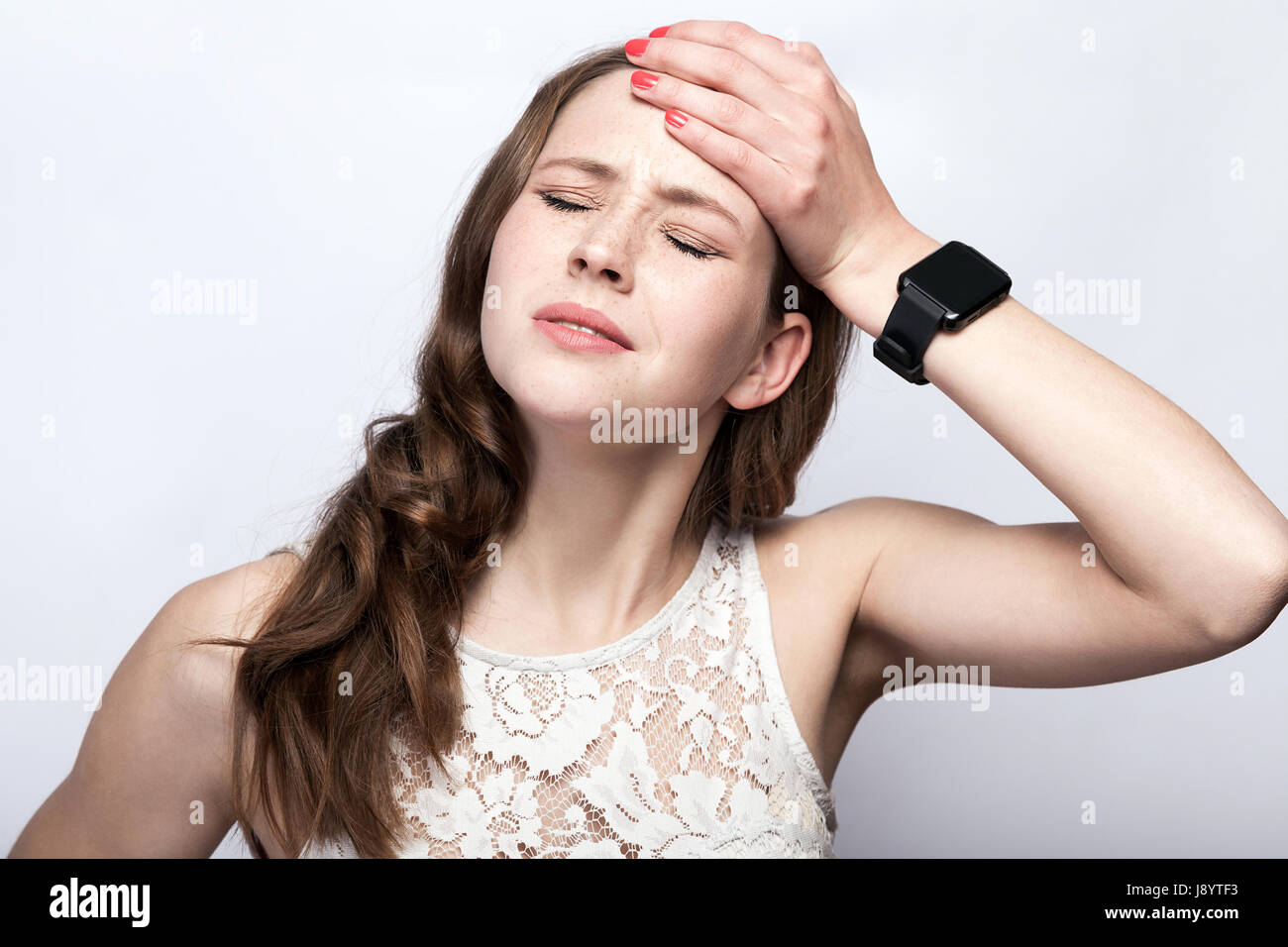 Portrait of beautiful woman with freckles and white dress and smart ...