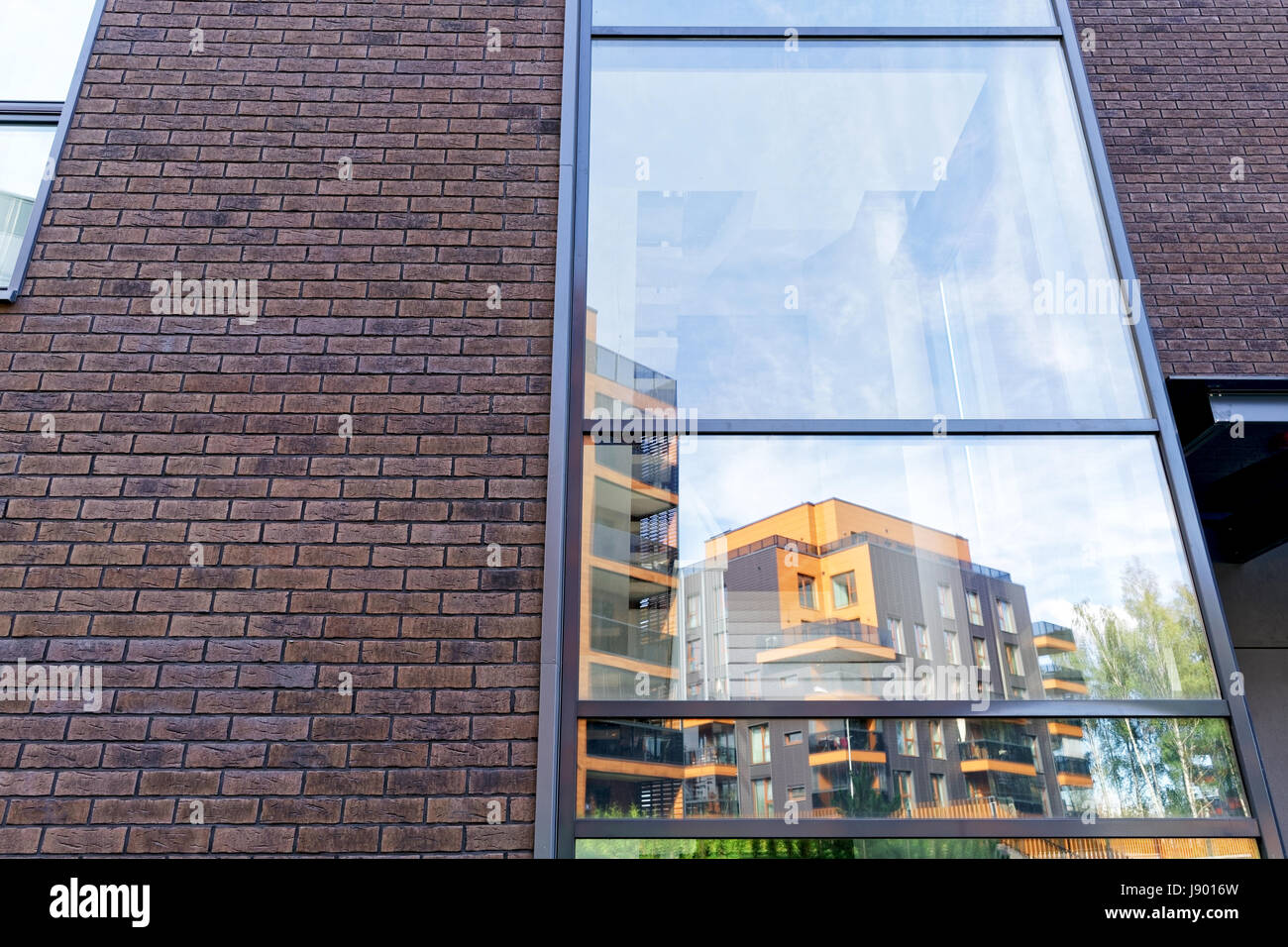 Reflection in a glass window of Modern architectural complex of ...