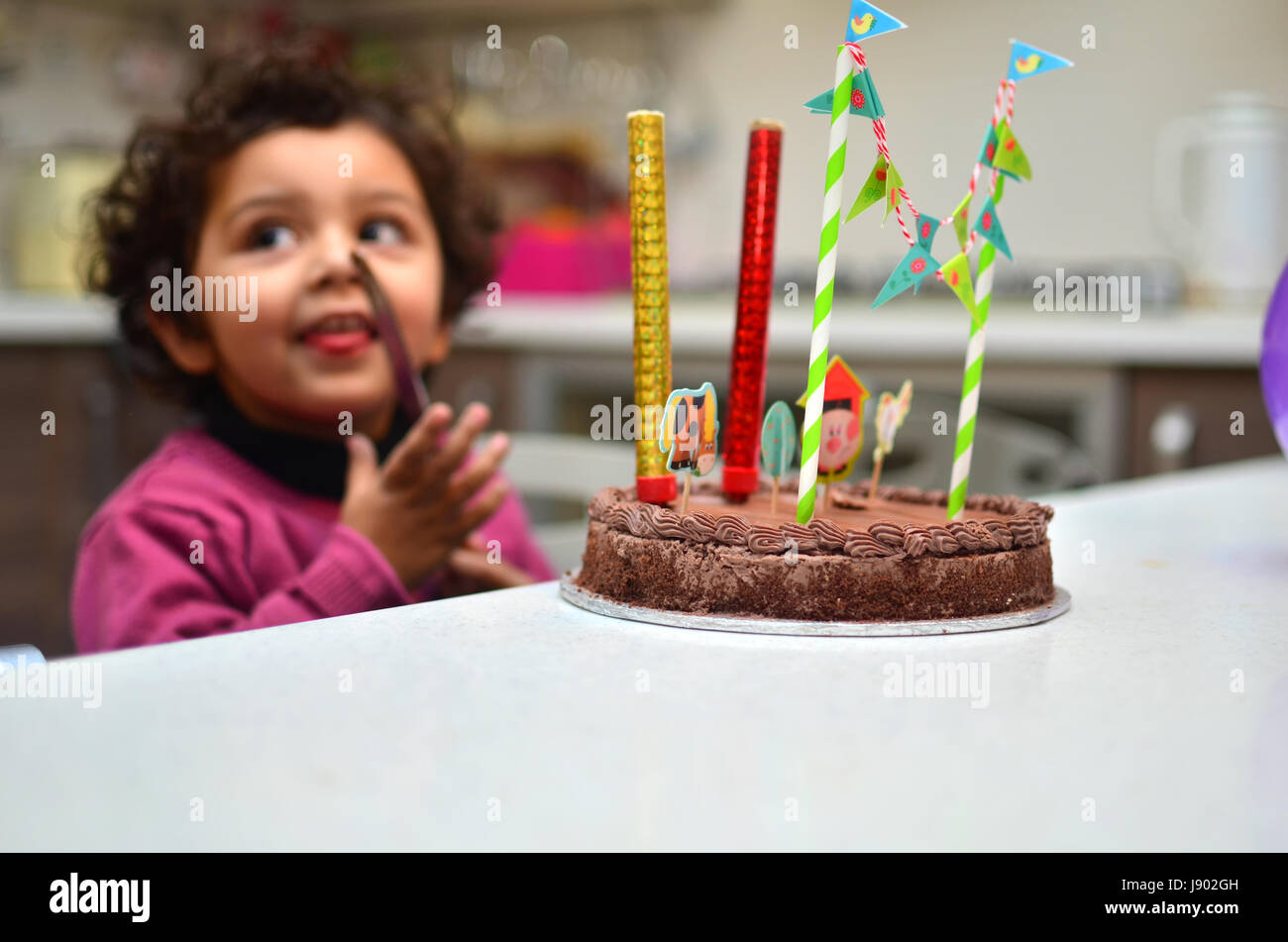 A Girl Enjoying While Blowing Candles And Cutting Her Birthday Cake