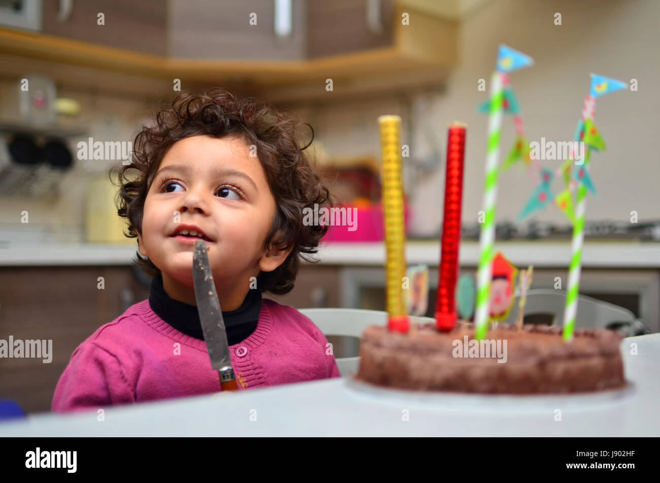 A Girl Enjoying While Blowing Candles And Cutting Her Birthday Cake