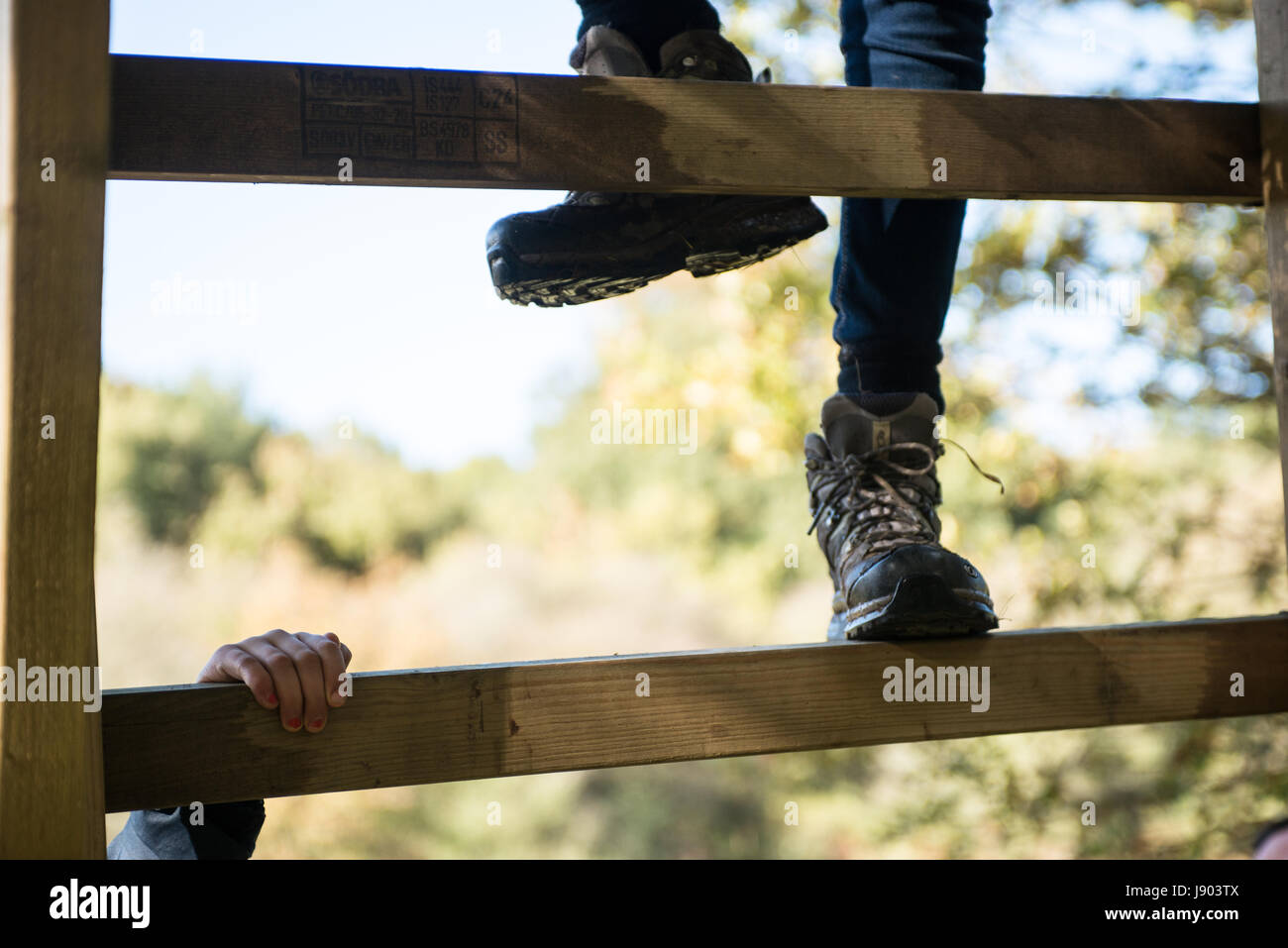 climbing over fence Stock Photo - Alamy