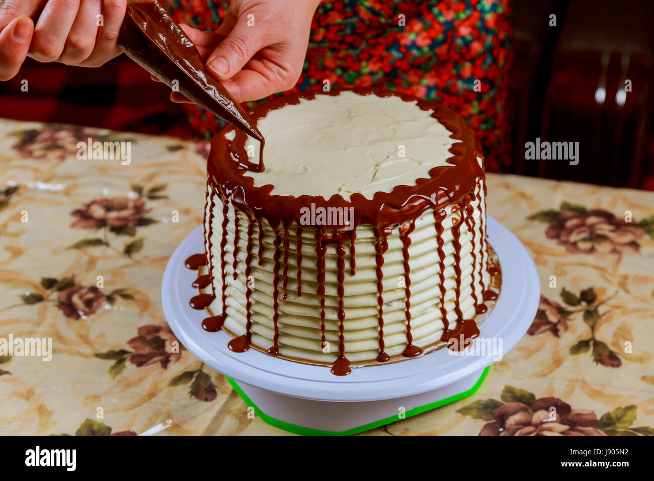 covering a cake with chocolate icing sponge cake covered in chocolate ...