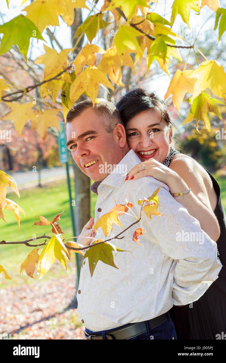 Romantic young beautiful couple walking in autumn city park Stock Photo ...