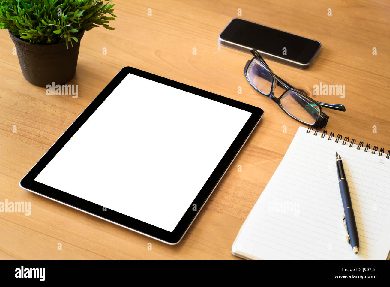 white screen tablet on desktop Stock Photo - Alamy