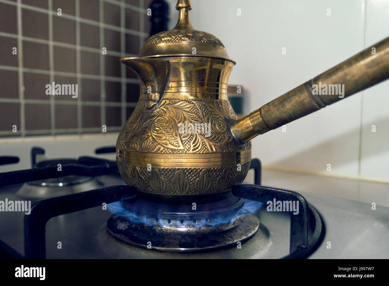 bronze coffee pot on gas cooker Stock Photo - Alamy