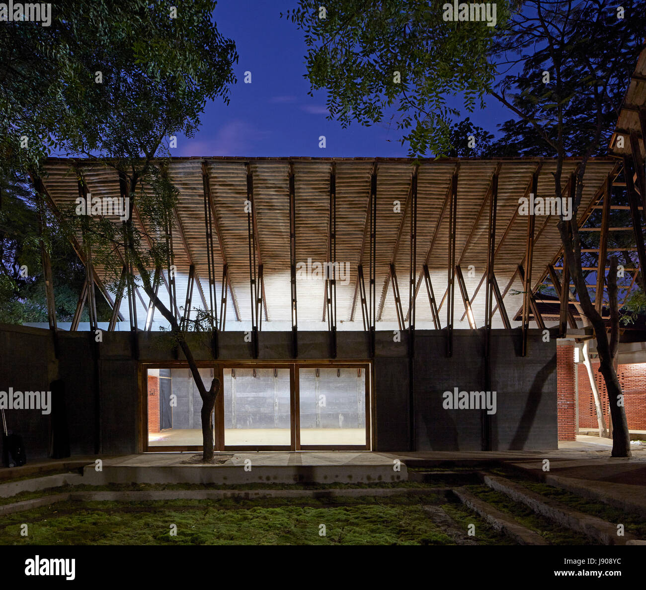 Courtyard view at dusk. Jetvanaa, Sakharwadi, India. Architect: SP+a ...
