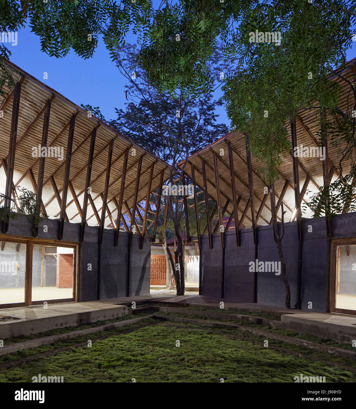 Courtyard view at dusk. Jetvanaa, Sakharwadi, India. Architect: SP+a ...