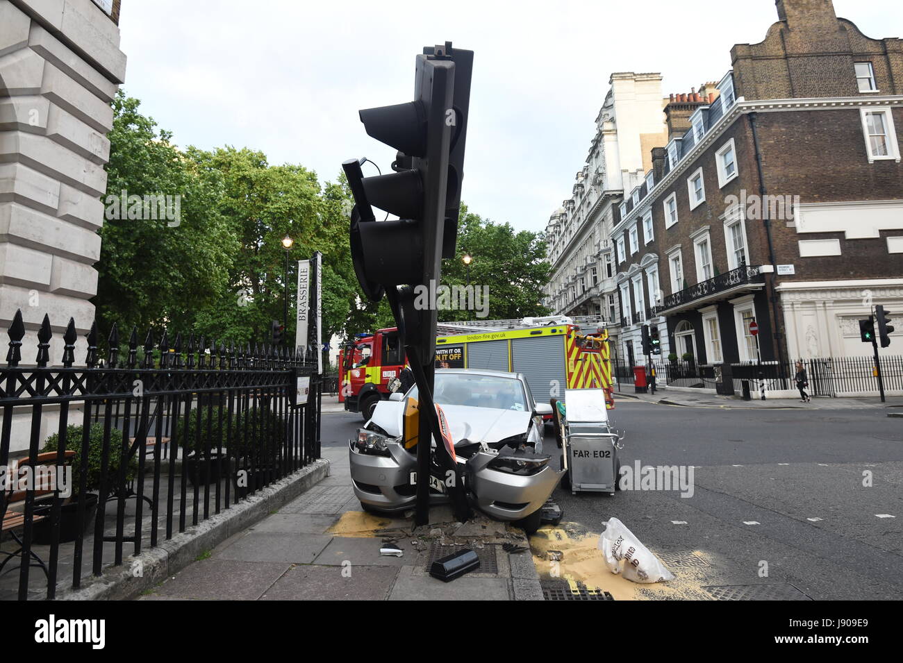 Emergency services attend the scene after a car crashed into a lamp ...