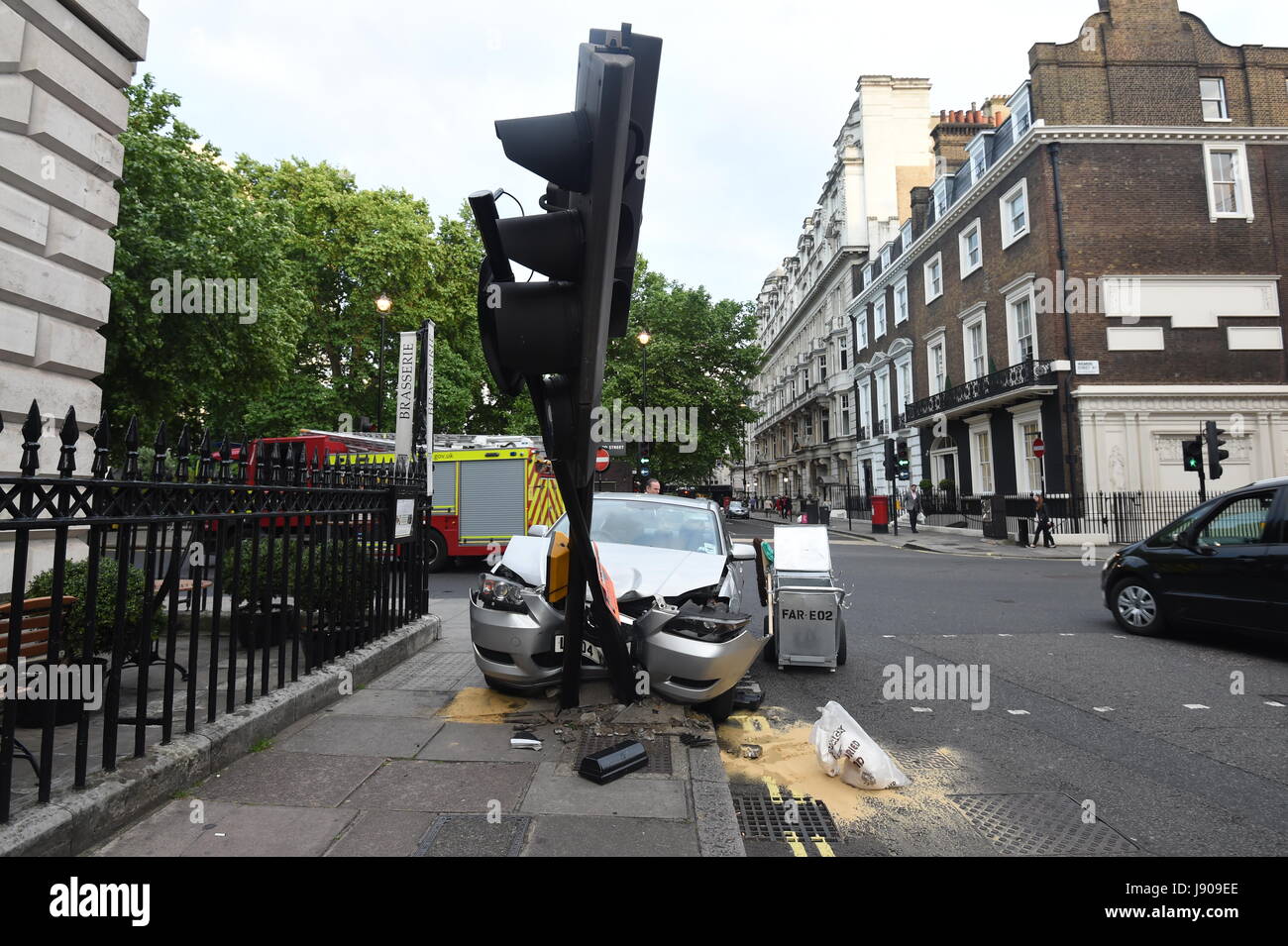 Emergency services attend the scene after a car crashed into a lamp ...