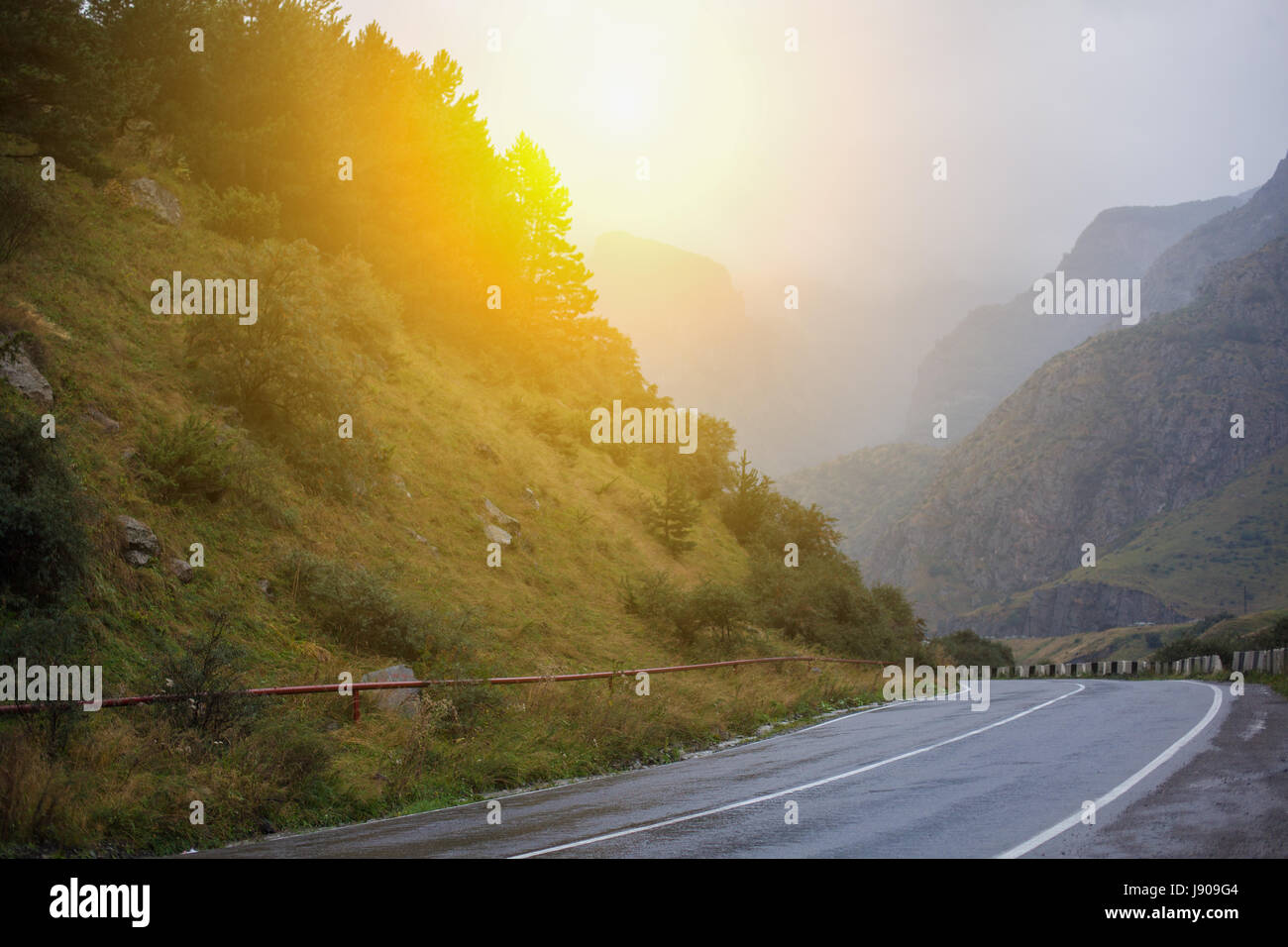 Cinematic road landscape. Asphalt Road throuth the mountains. With ...