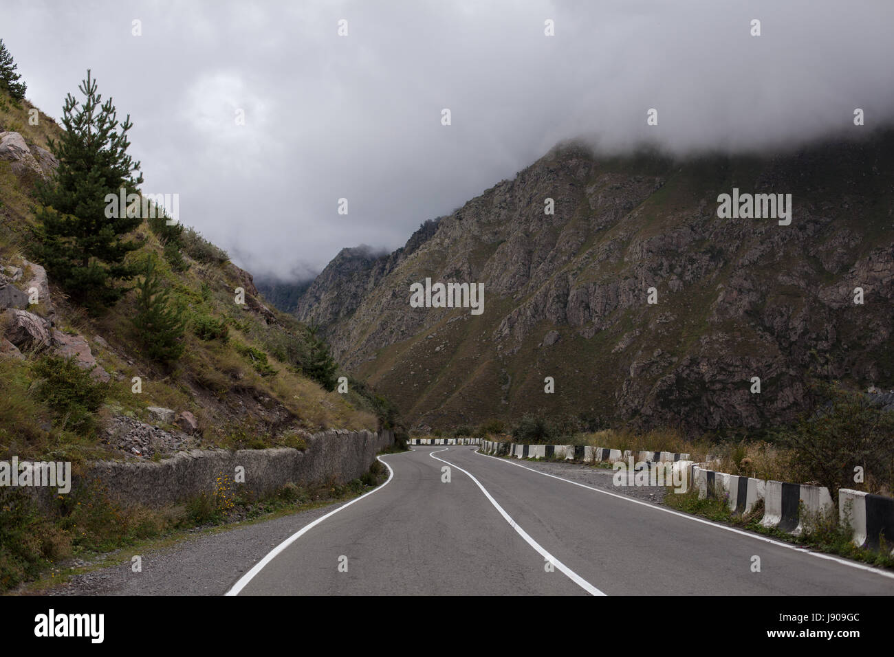 Cinematic road landscape. Asphalt Road throuth the mountains. With ...