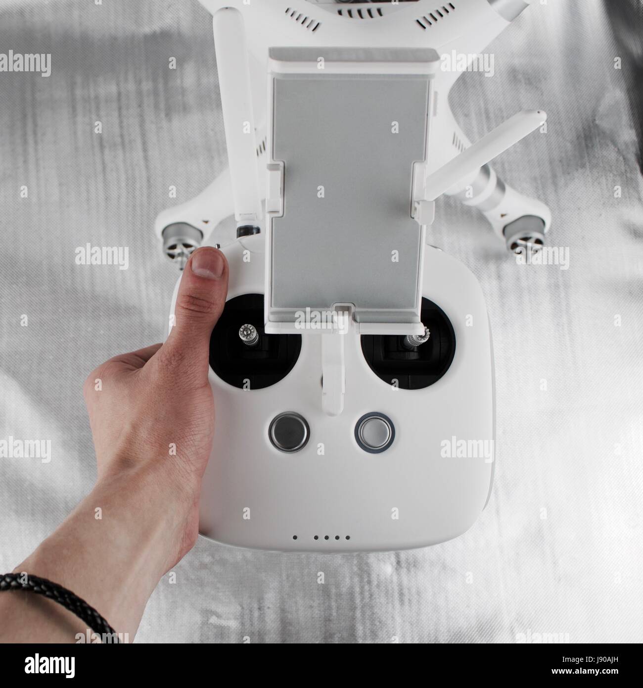 White big drone controller in hand near white quadcopter Stock Photo ...