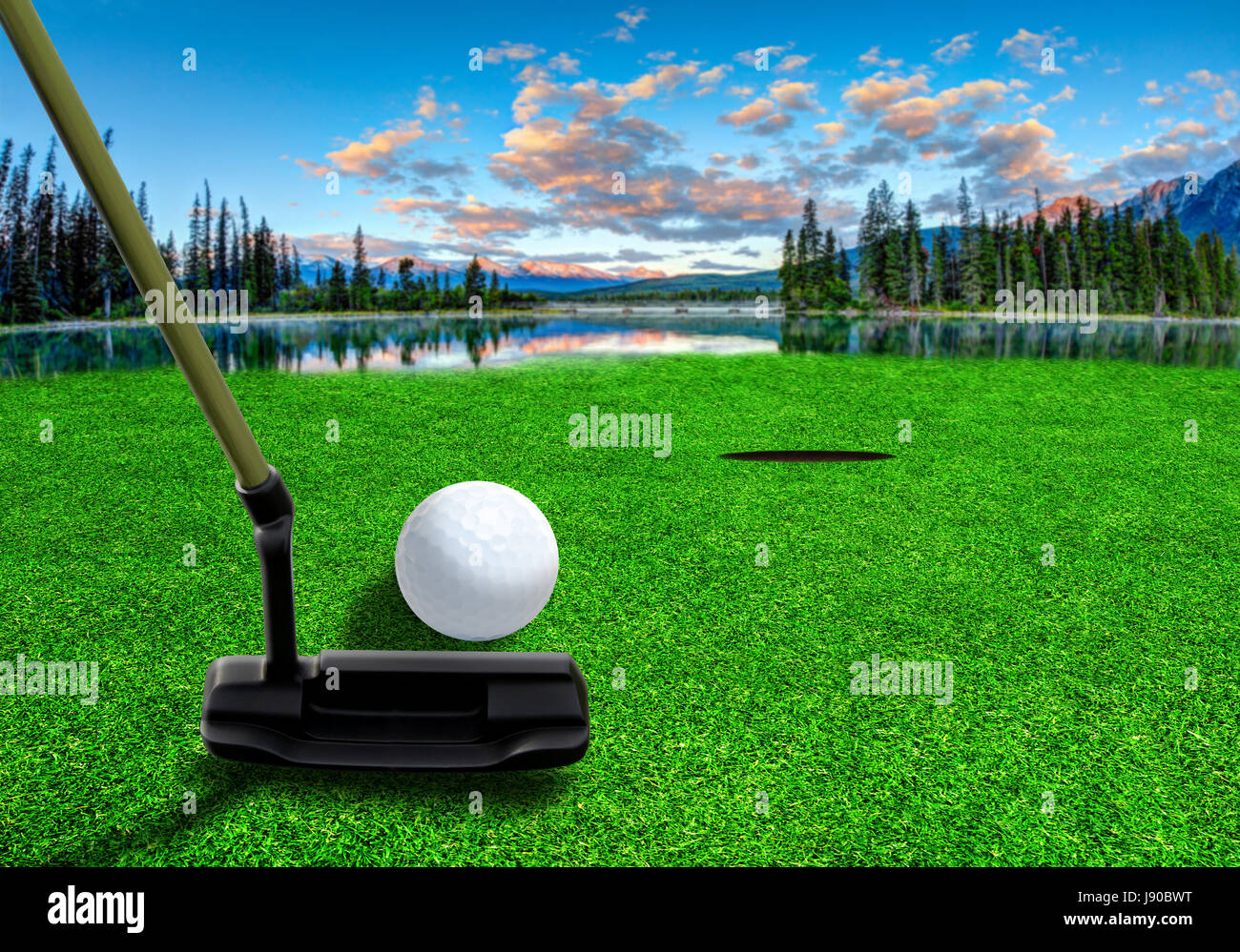 Golfer using a putter club to hit a golf ball on a beautiful golf ...