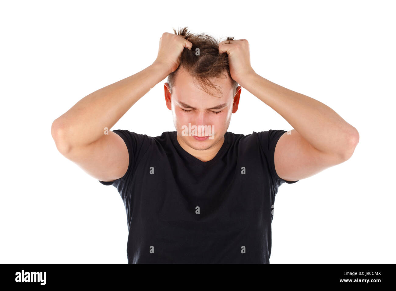 Picture of a nervous young man standing on an isolated background Stock ...