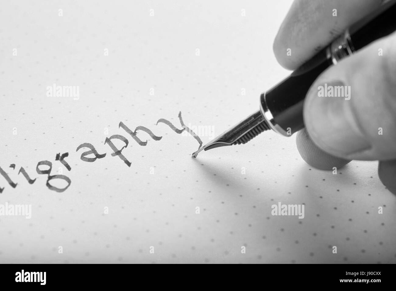 Hand holding a fountain pen to write on paper Stock Photo - Alamy