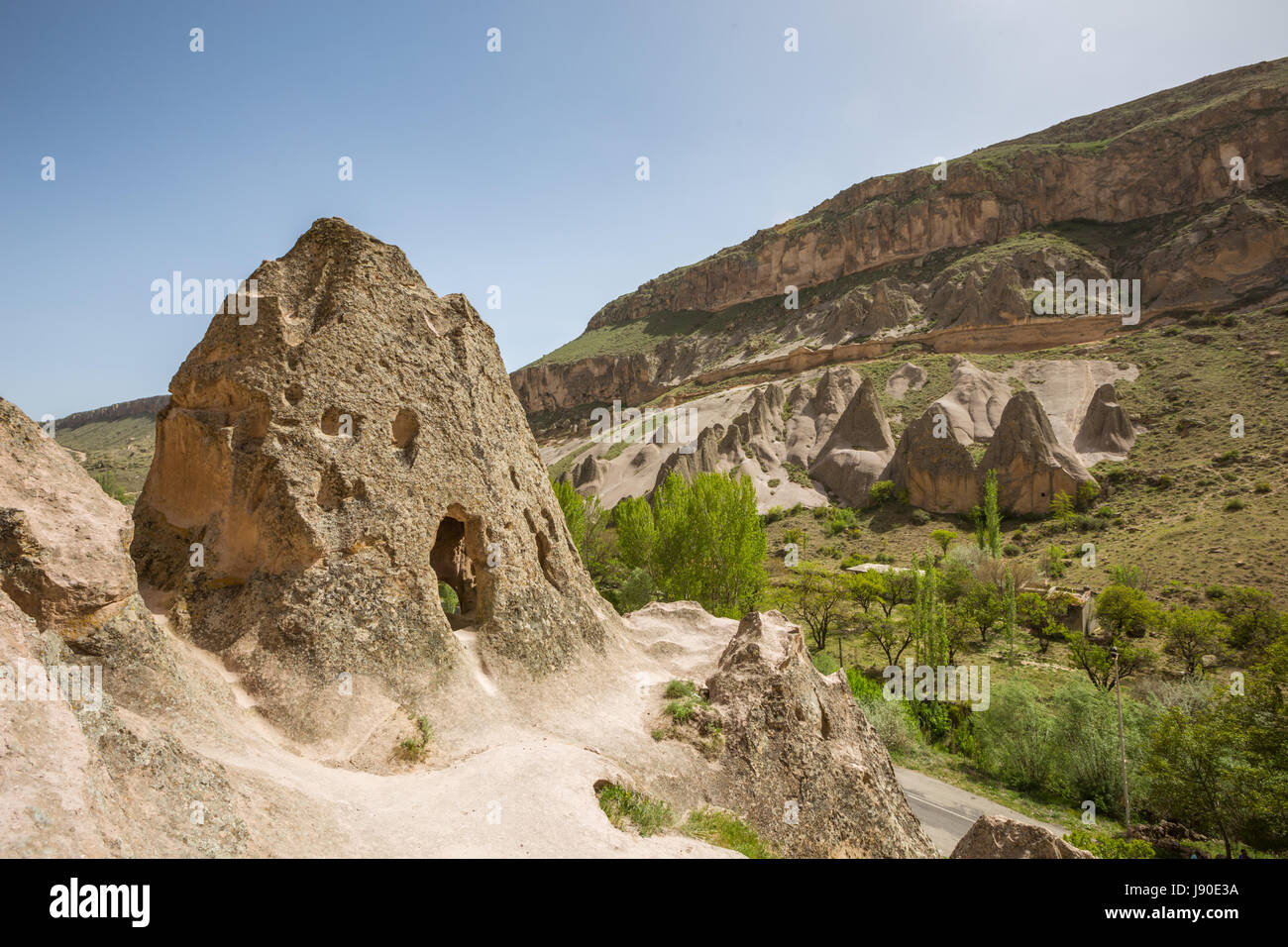 Ancient cave house in Soganli valley on the background of the blue sky ...