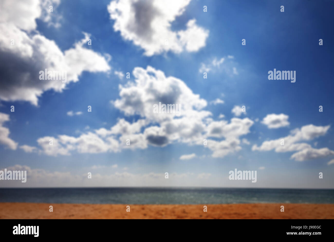 Blurred sea beach in sun summer day and sky with clouds. Use as ...
