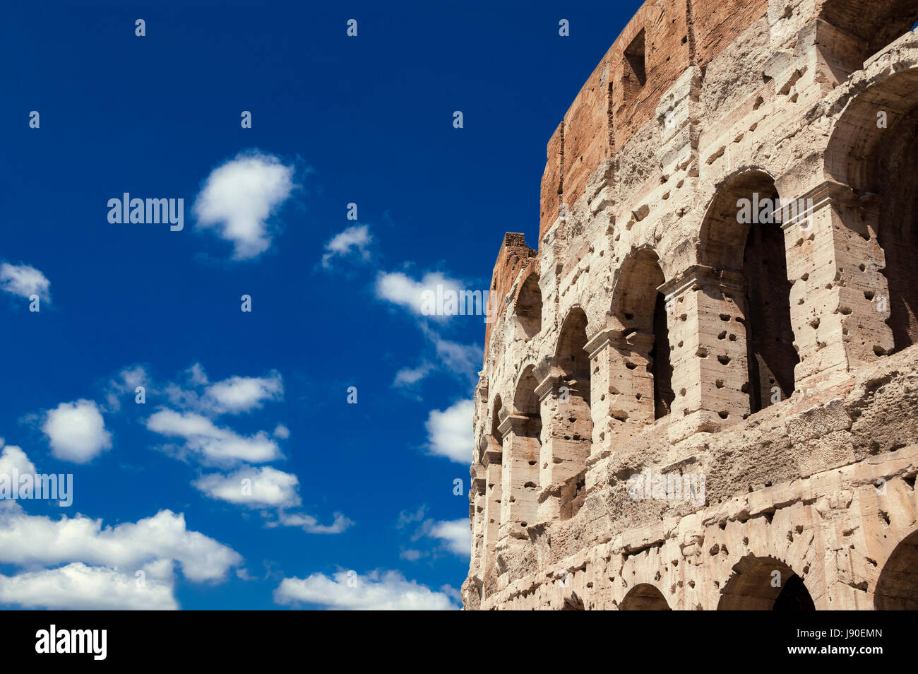 Coliseum monumental arcades with blue sky in Rome Stock Photo - Alamy