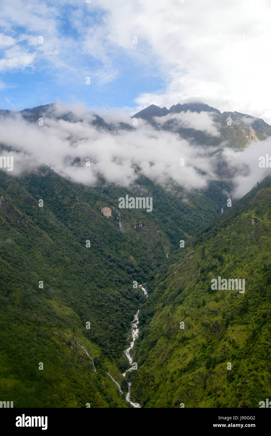 Mountains of Nepal. Beautiful helicopter view of a river valley between ...
