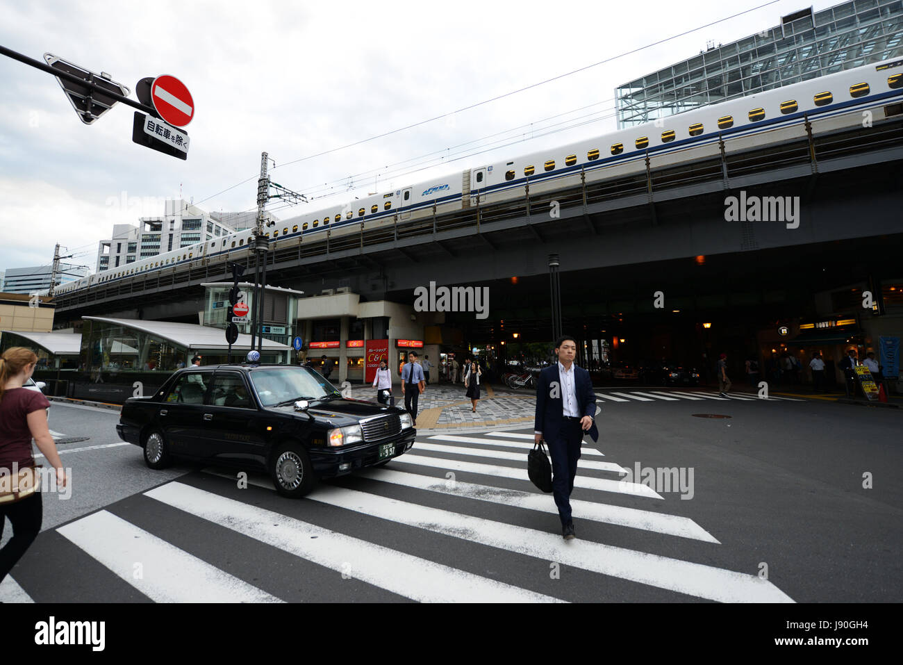 A Japanese businessman crossing the pedestrian crossing near Yurakucho ...