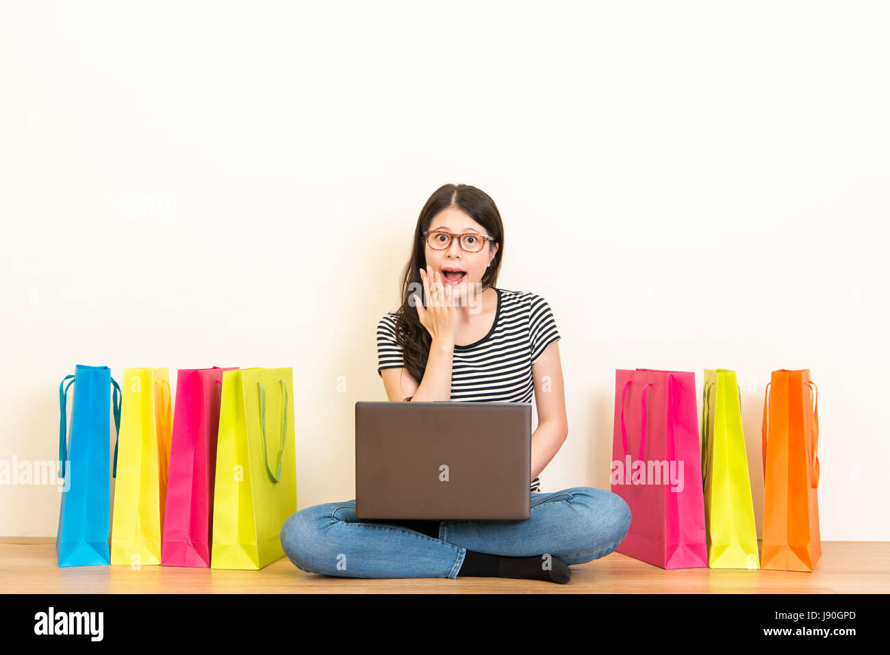 young girl using the laptop computer finding surprises information when ...
