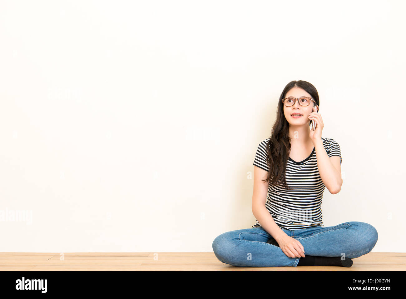 charming woman calling with cell telephone while sitting alone on ...