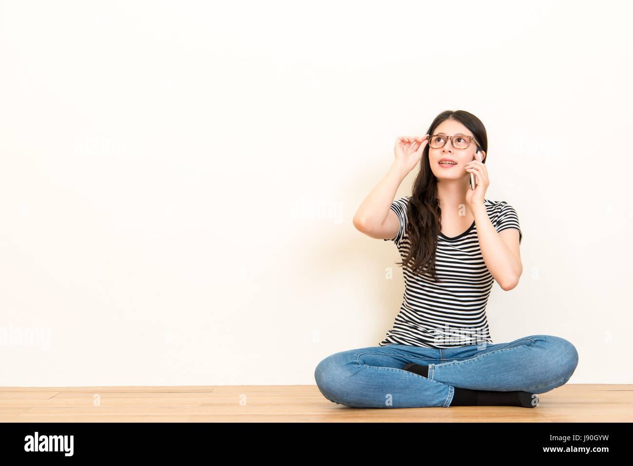 mixed race asian chinese student using mobile talking with classmate ...