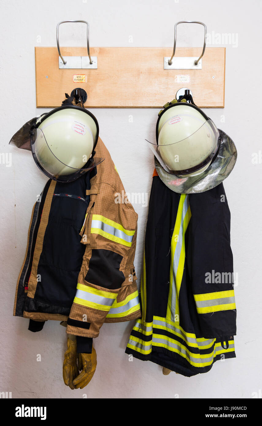 A brown and a dark blue service uniforms of the airport's fire brigade ...
