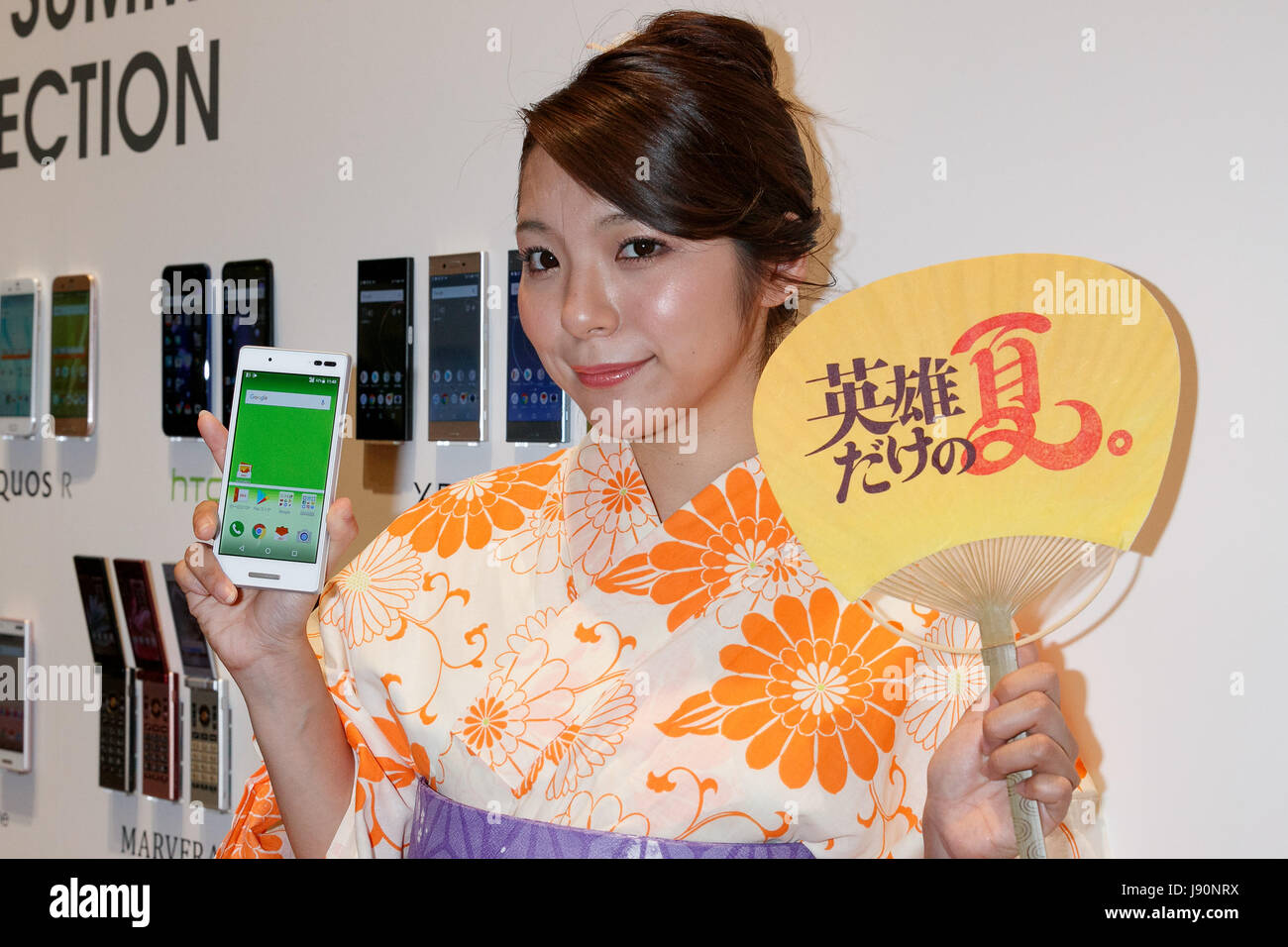 A model wearing traditional Japanese kimono shows off a new mobile ...