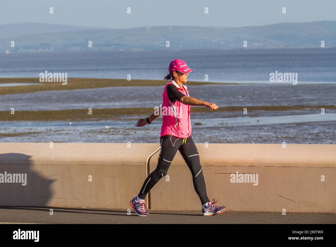 woman striding out in Morecambe Bay, Lancashire. UK Weather. 31st May ...