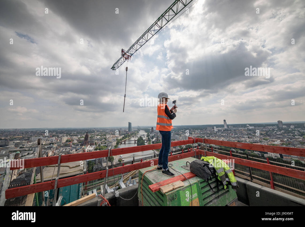 A journalist shoots a video on top of the building shell of the 110 ...